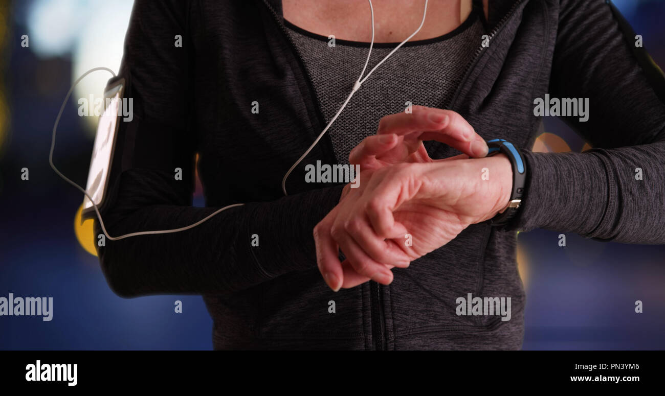 Close-up of mature woman jogger using smartwatch Stock Photo - Alamy