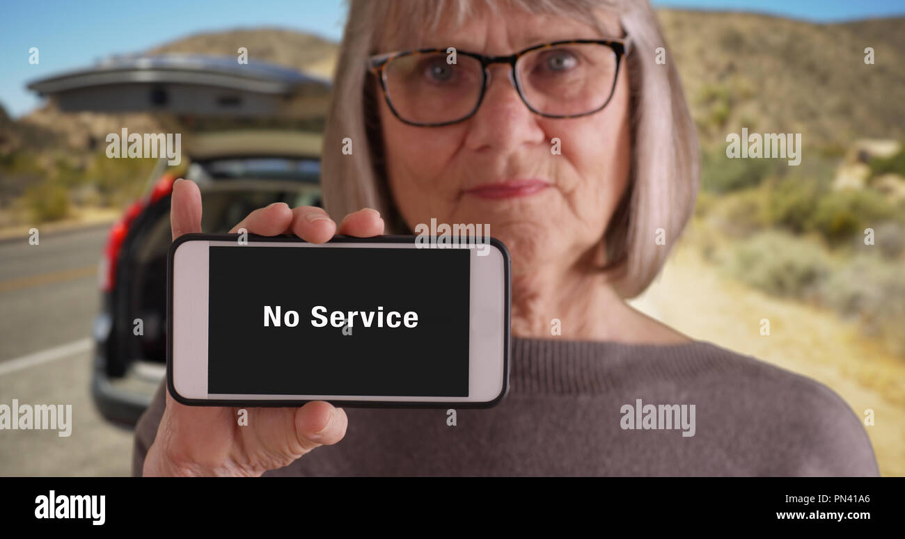 Somber looking old woman pulled over on desert road with no service on ...