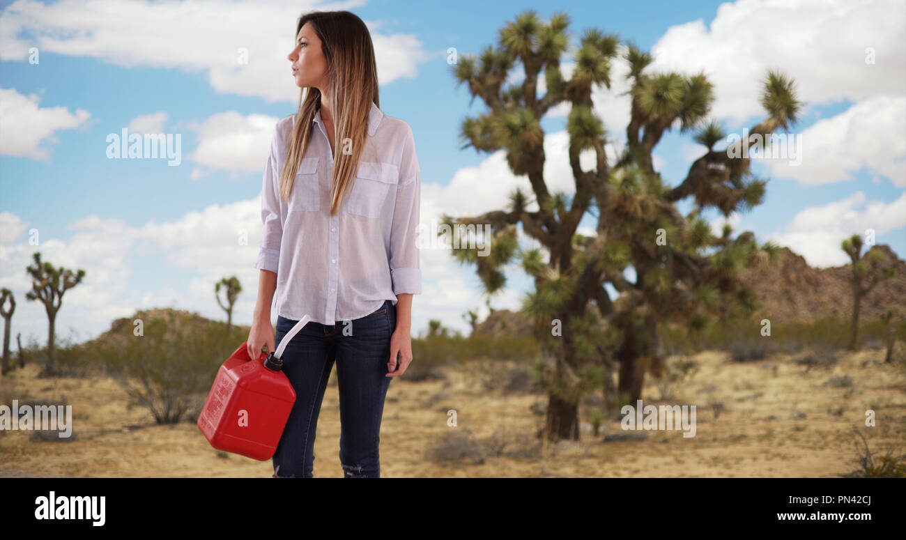 Stranded female motorist with red gas can looking for help in middle of ...