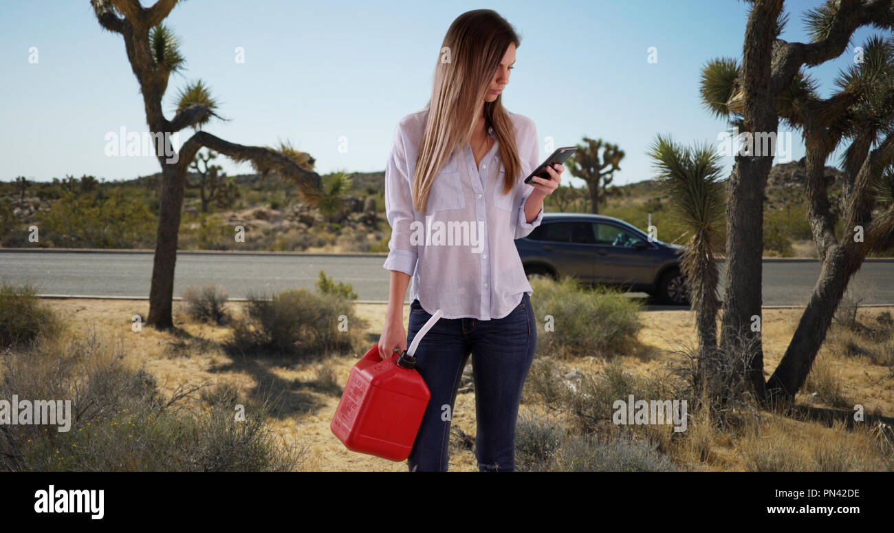 Lost female with gas can getting directions on phone after running out ...