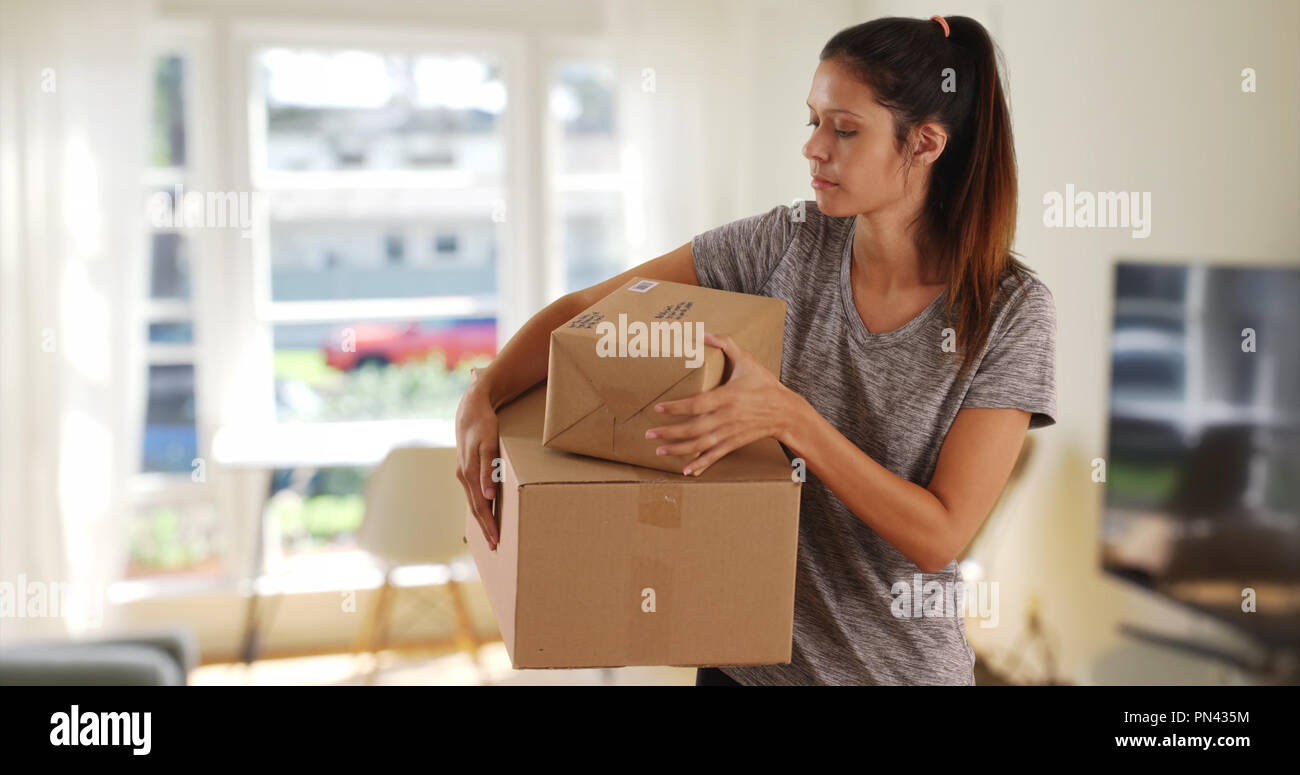 Beautiful Caucasian woman at home carrying shipping boxes Stock Photo ...