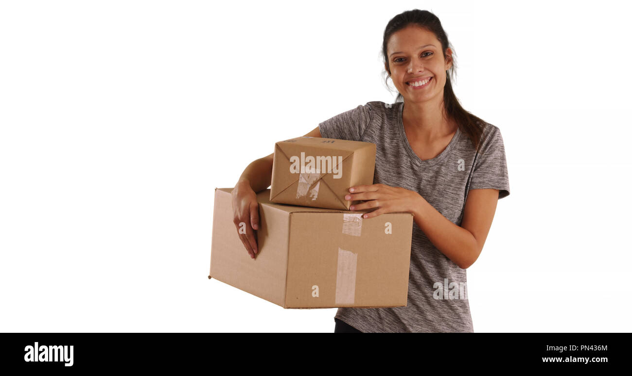 Beautiful smiling Caucasian woman holding shipping boxes on white ...