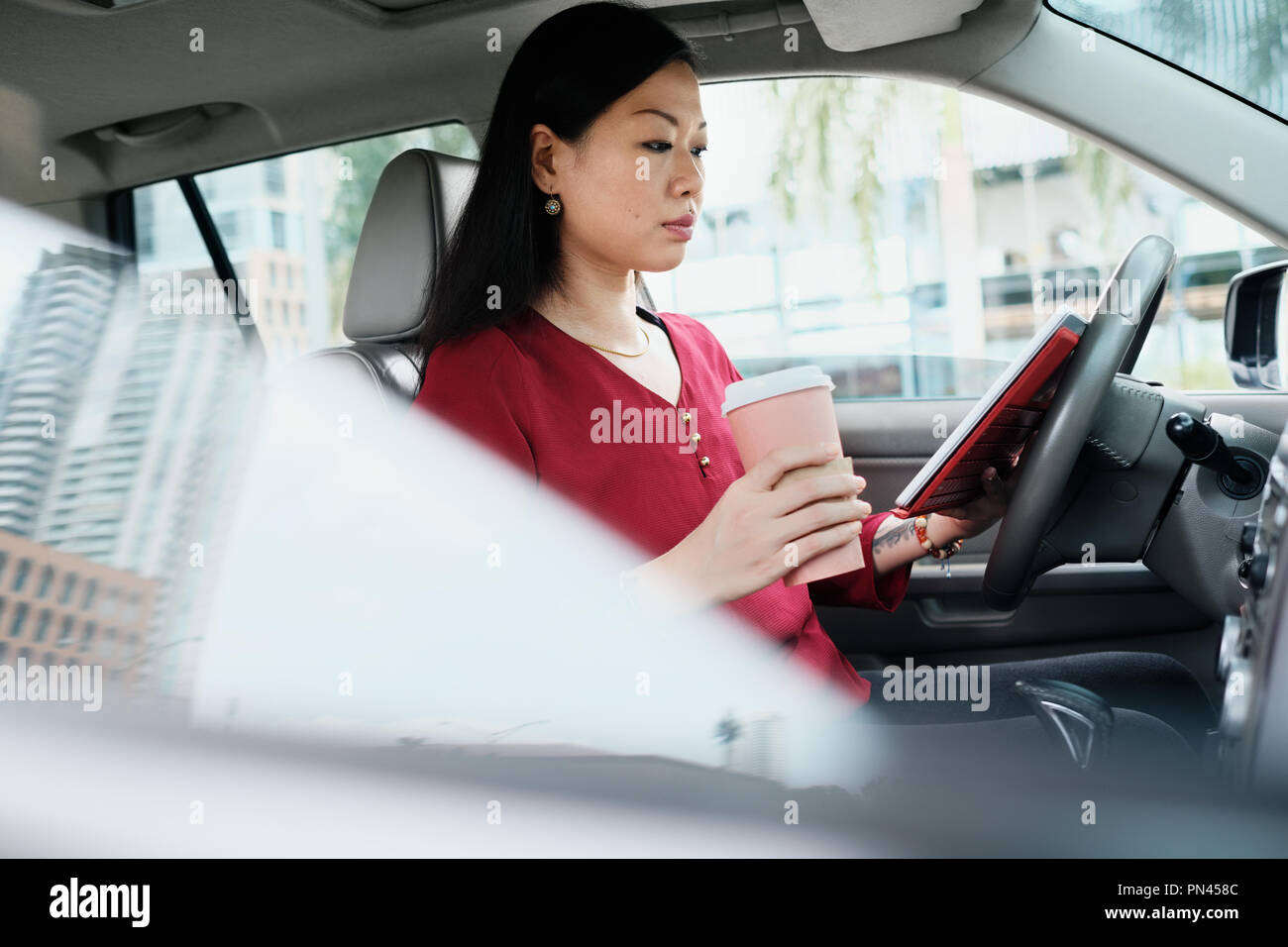 Busy Chinese Business Woman Working In Car With Tablet Stock Photo - Alamy