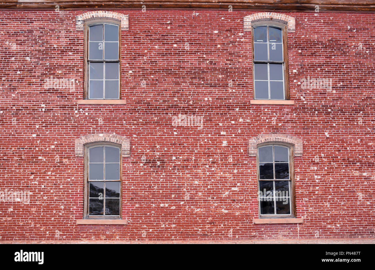 Four windows on an old brick wall Stock Photo - Alamy