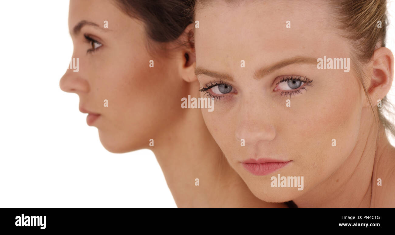 Tight shot of model's face with make-up posing for camera on white copy ...