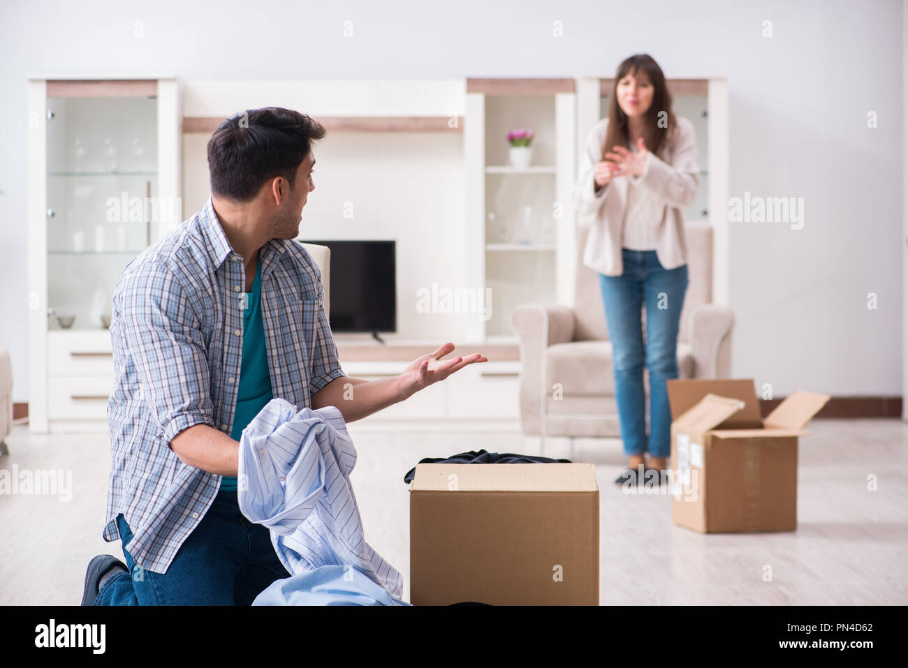 Woman evicting man from house during family conflict Stock Photo - Alamy