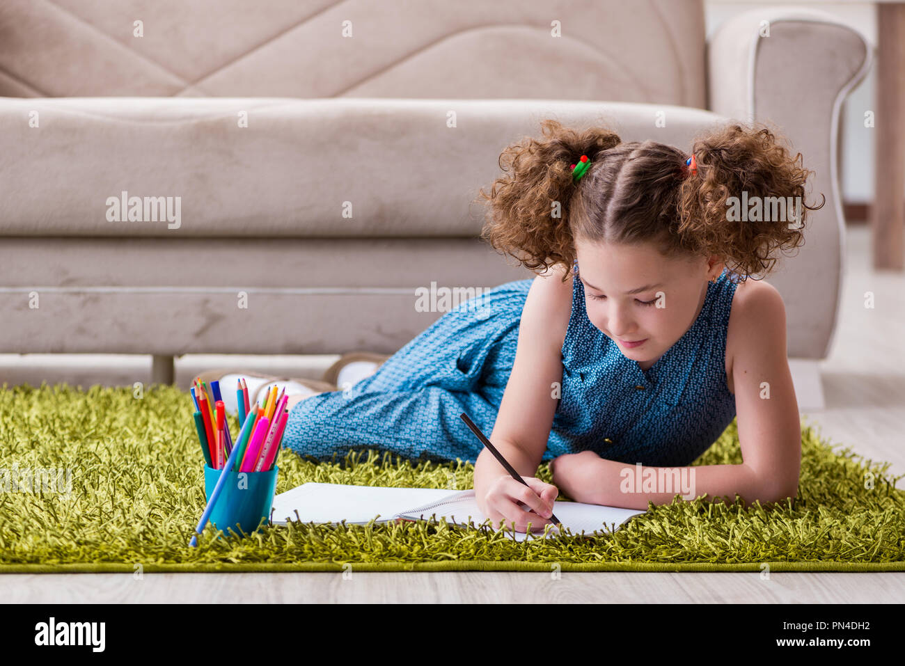 Young little girl drawing on paper with pencils Stock Photo - Alamy