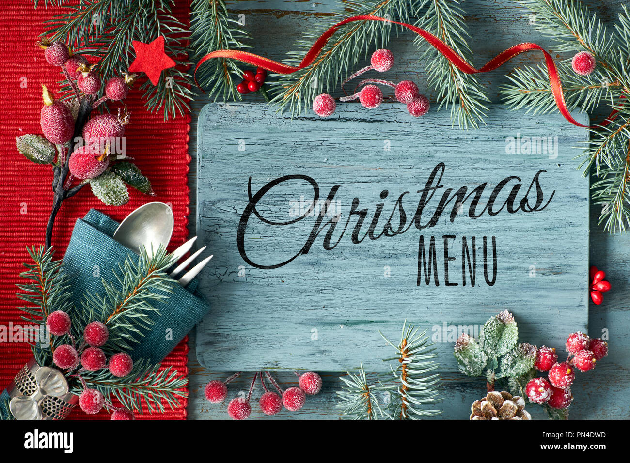 "Christmas menu" text on rustic board framed with various Xmas ...
