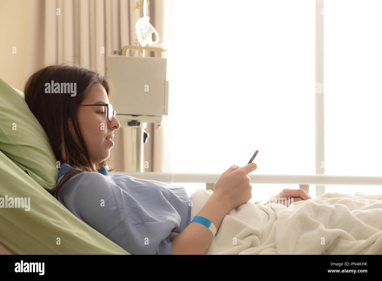 beautiful young patient women lying in hospital bed and smiling with ...