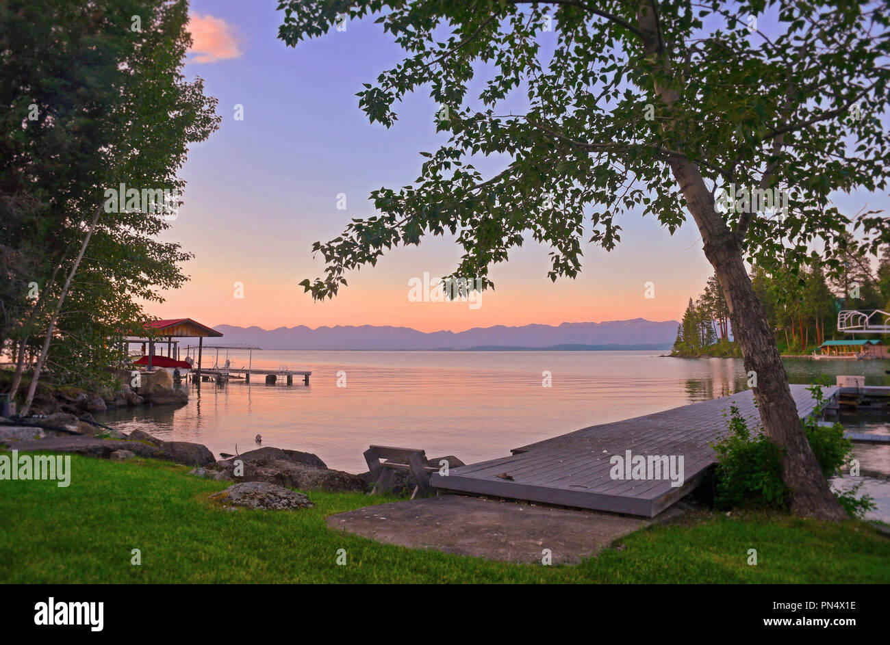 Colors of sunset reflect on the Swan Mountain Range and Flathead Lake ...
