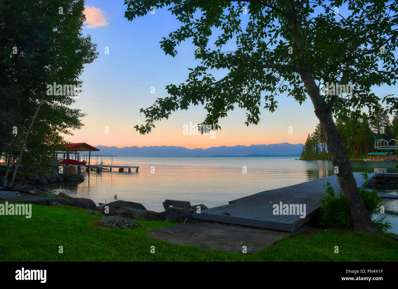 Colors of sunset reflect on the Swan Mountain Range and Flathead Lake ...