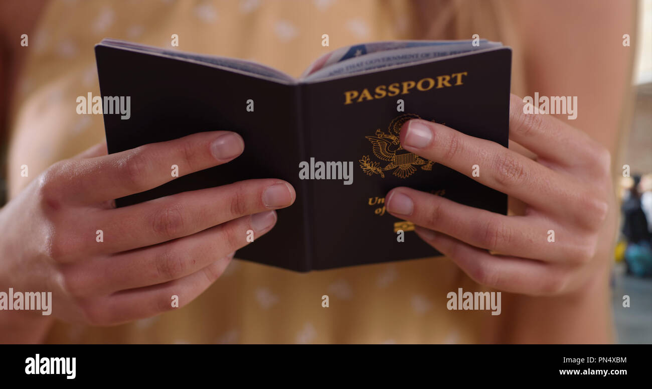 Woman traveler holding and reading US passport ready for international ...