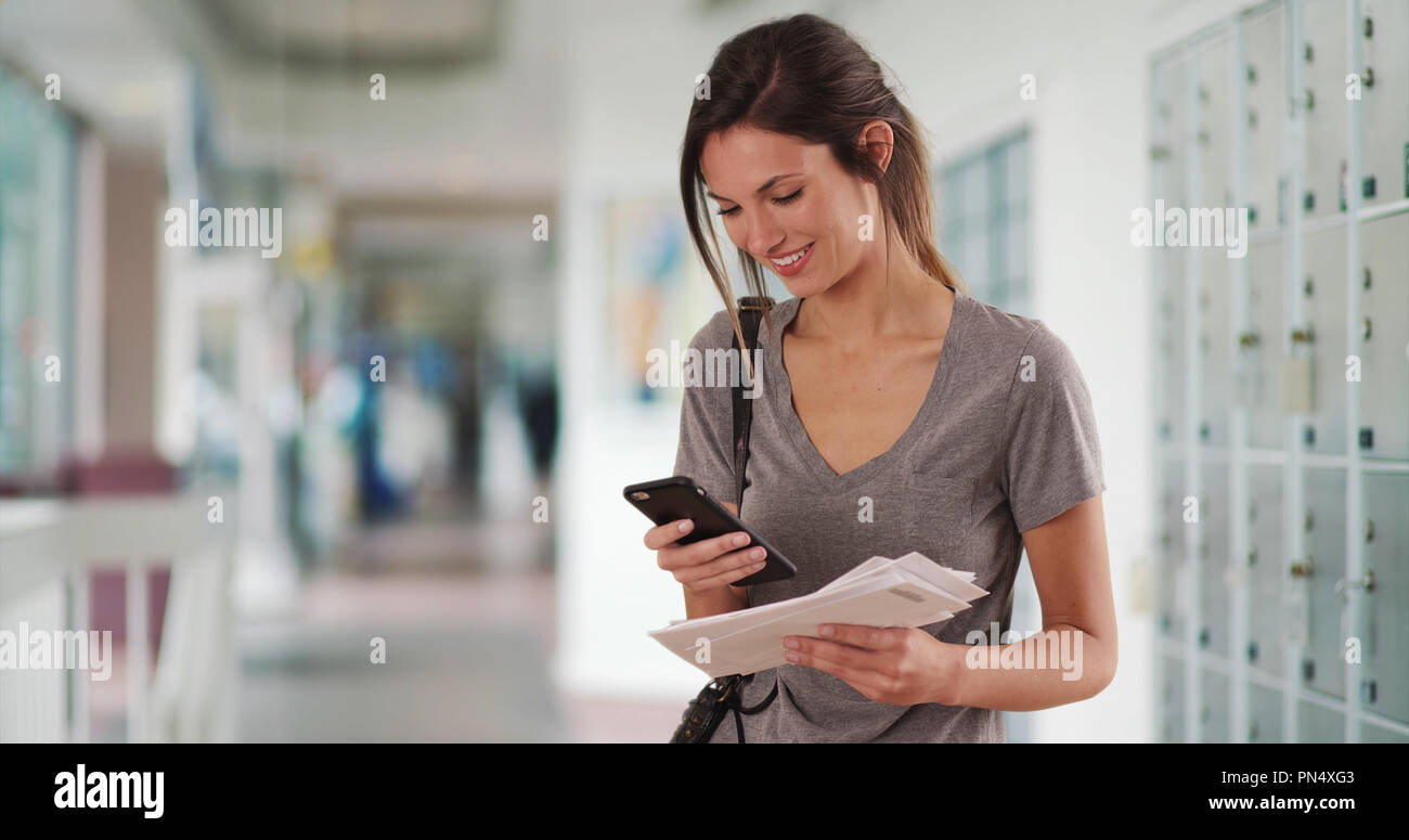 Millennial Caucasian girl holding letters texting on phone by parcel ...