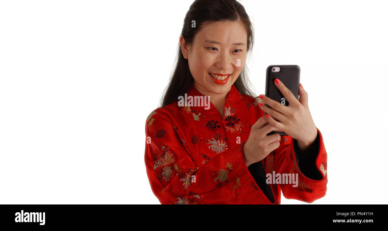 Close up of millennial female Chinese taking selfie isolated on white ...