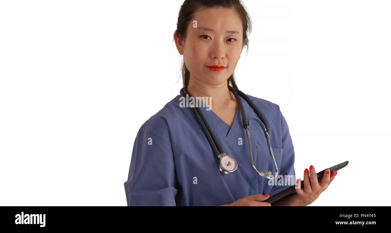 Smiling millennial nurse or doctor carrying portable tablet on white ...