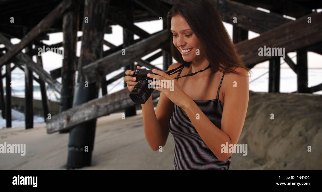 Pretty photographer at the beach taking picture with dslr camera Stock ...