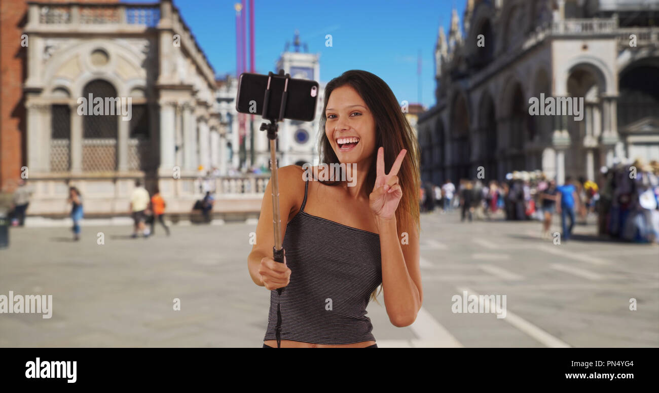 Pretty tourist woman in Venice taking fun selfies in St Marks Square ...