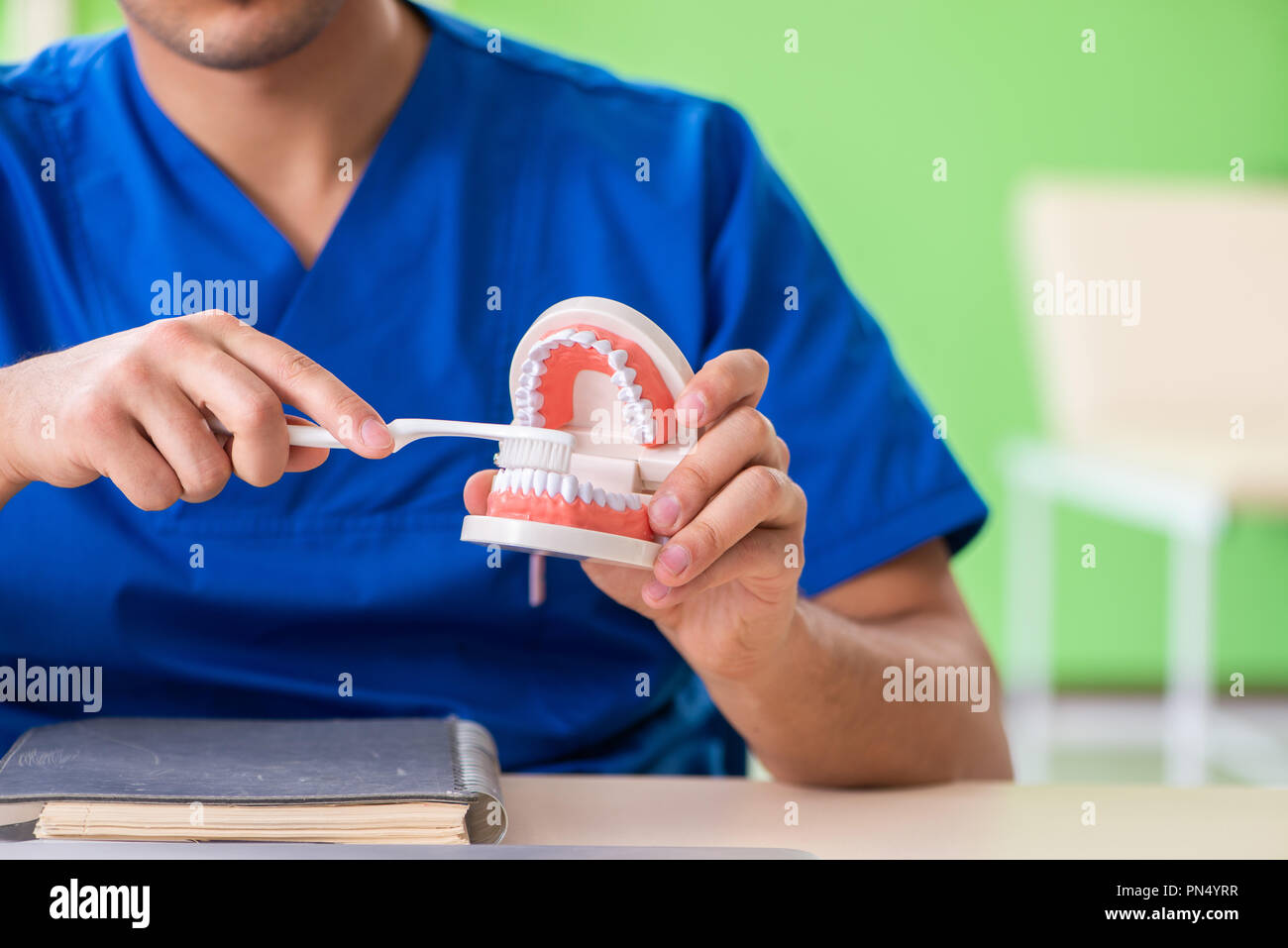 Man dentist working on new teeth implant Stock Photo - Alamy