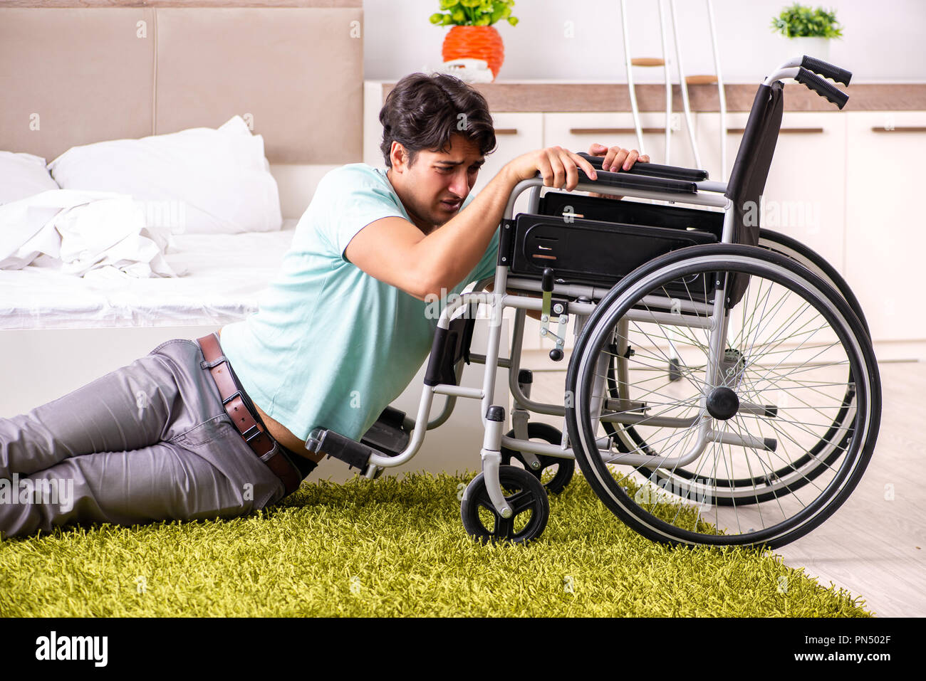 Young handsome disabled man recovering at home Stock Photo - Alamy