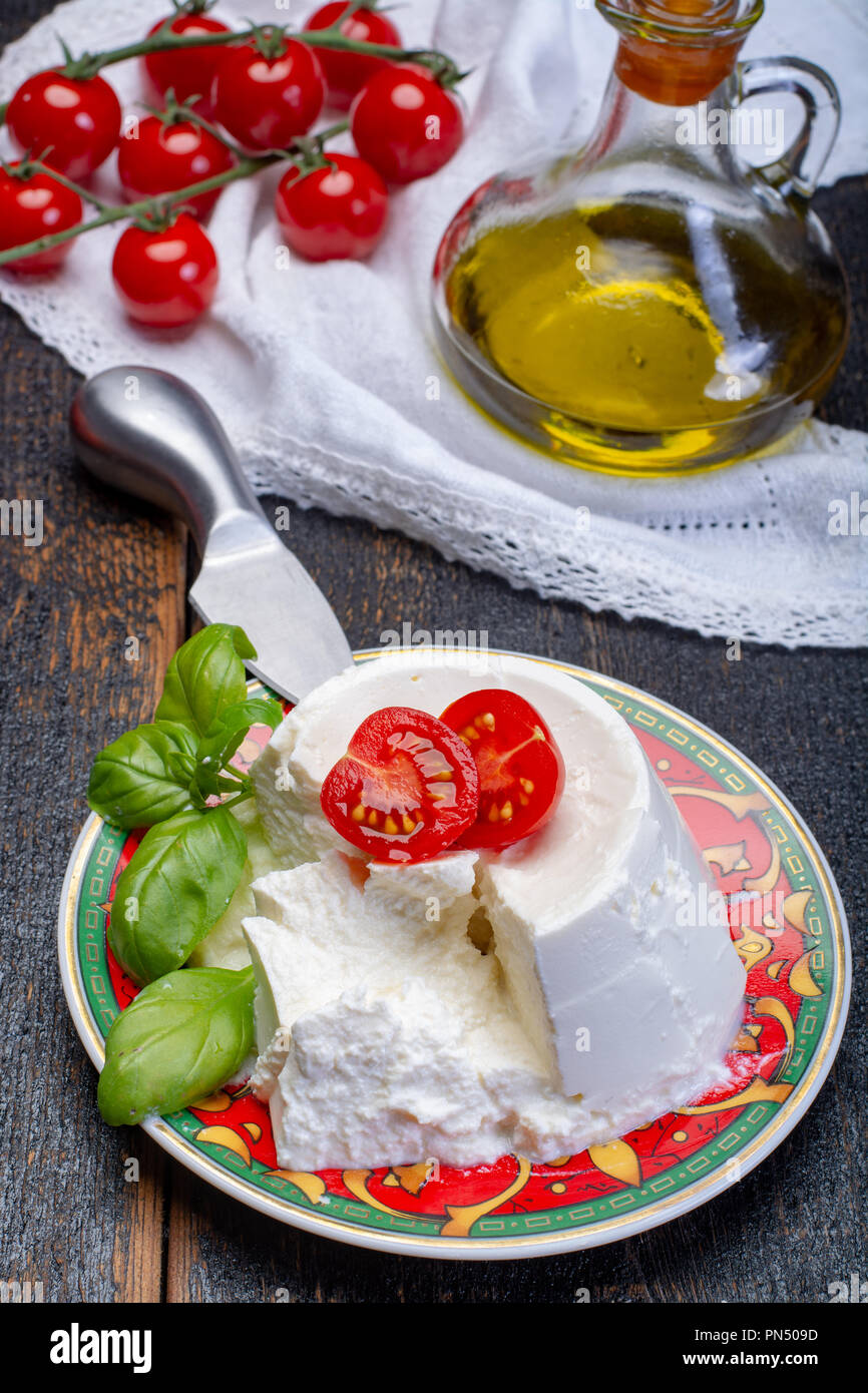 Italian soft cheese, young white ricotta cheese served with fresh basil ...