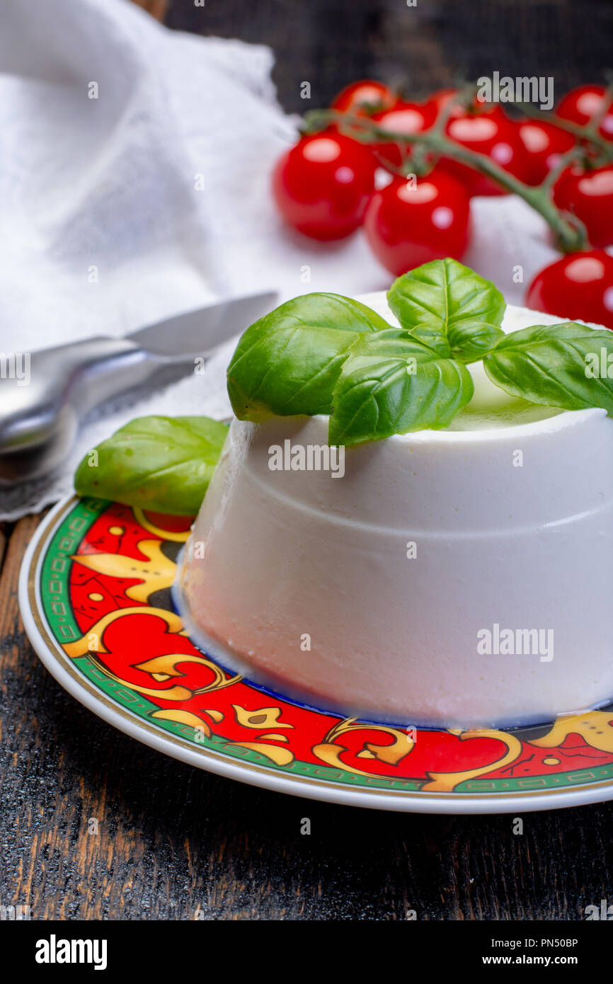 Italian soft cheese, young white ricotta cheese served with fresh basil ...
