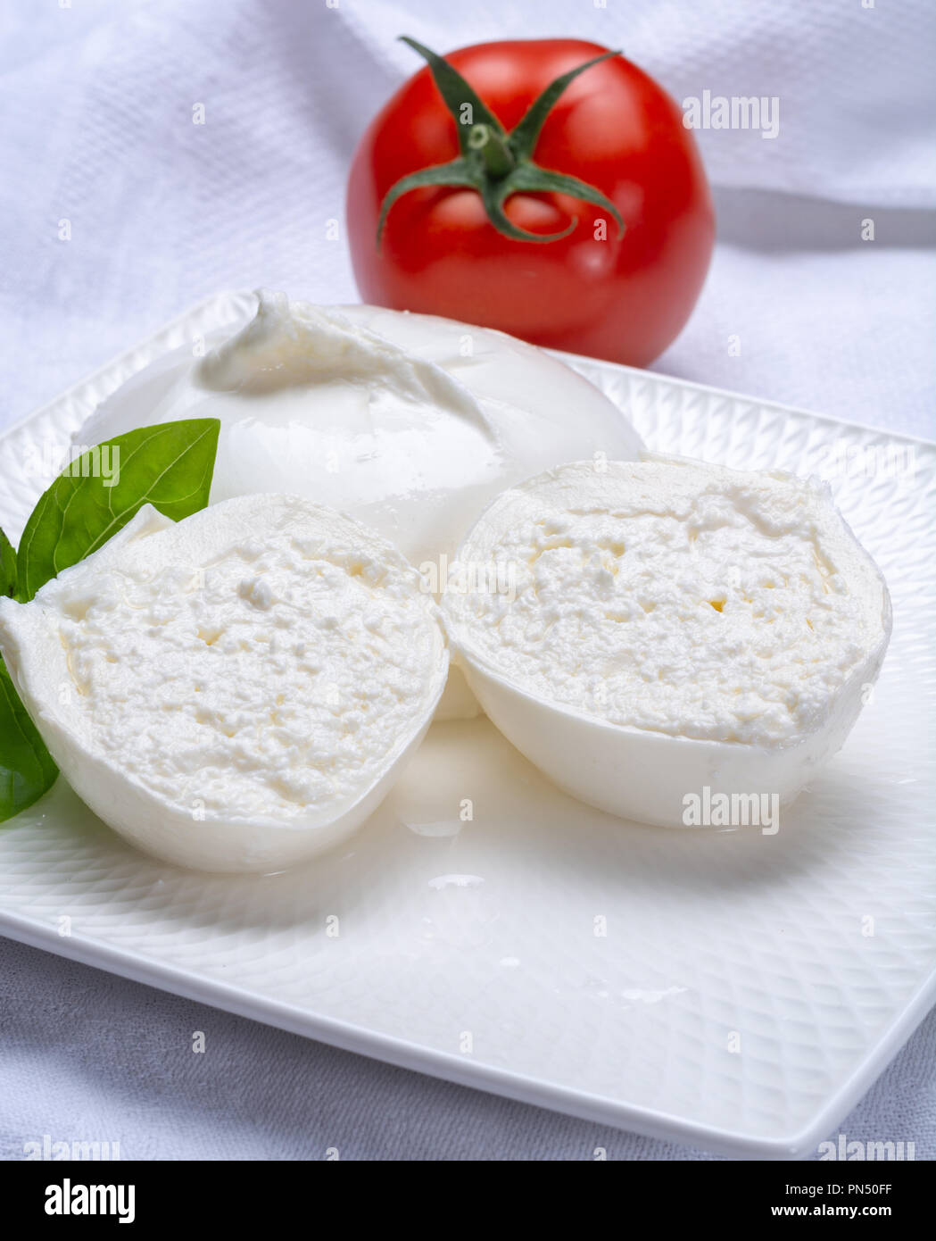Fresh soft white burrata, ball buttery cheese, made from a mix of ...