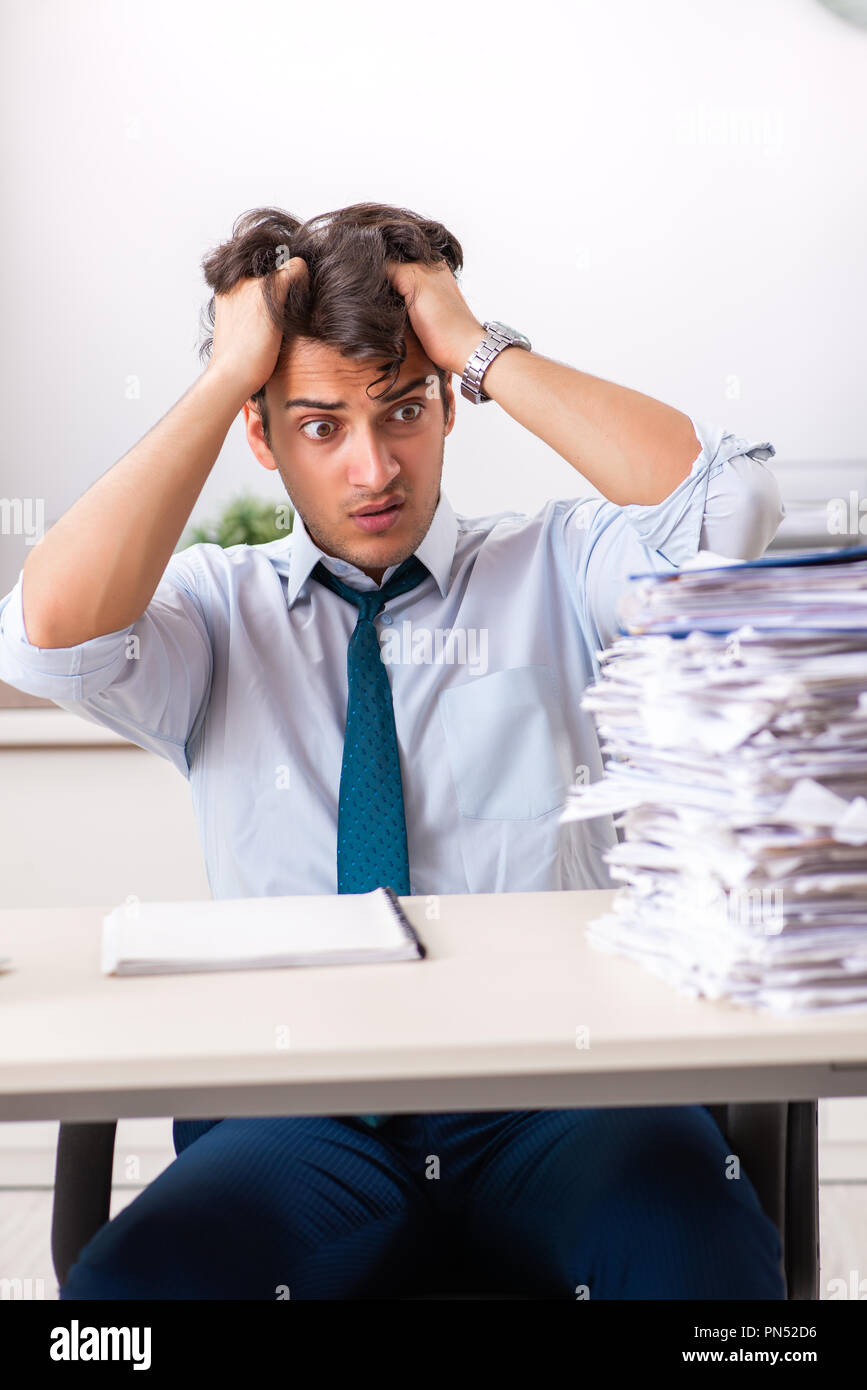 Overloaded busy employee with too much work and paperwork Stock Photo ...