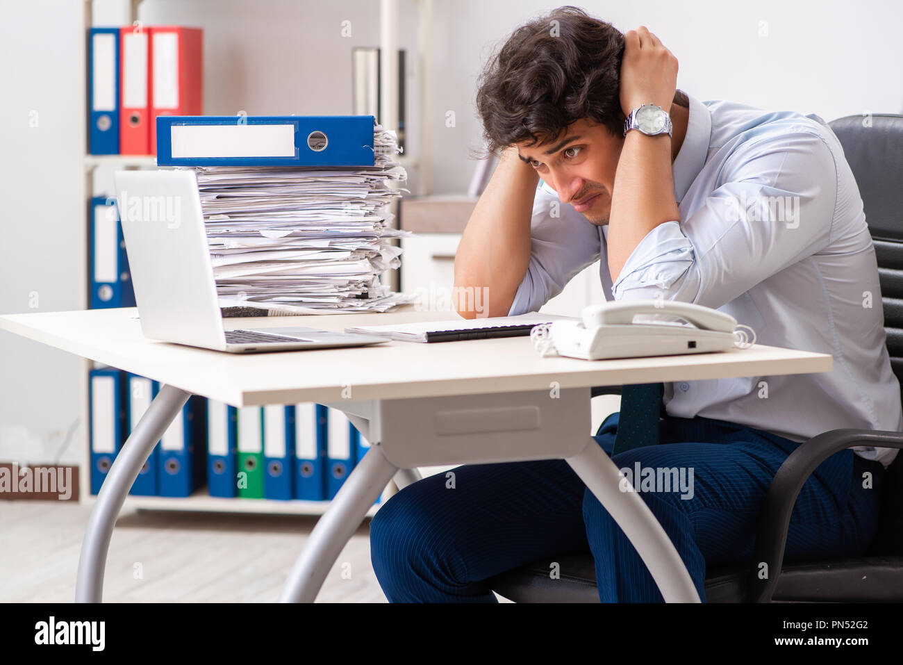 Overloaded busy employee with too much work and paperwork Stock Photo - Alamy