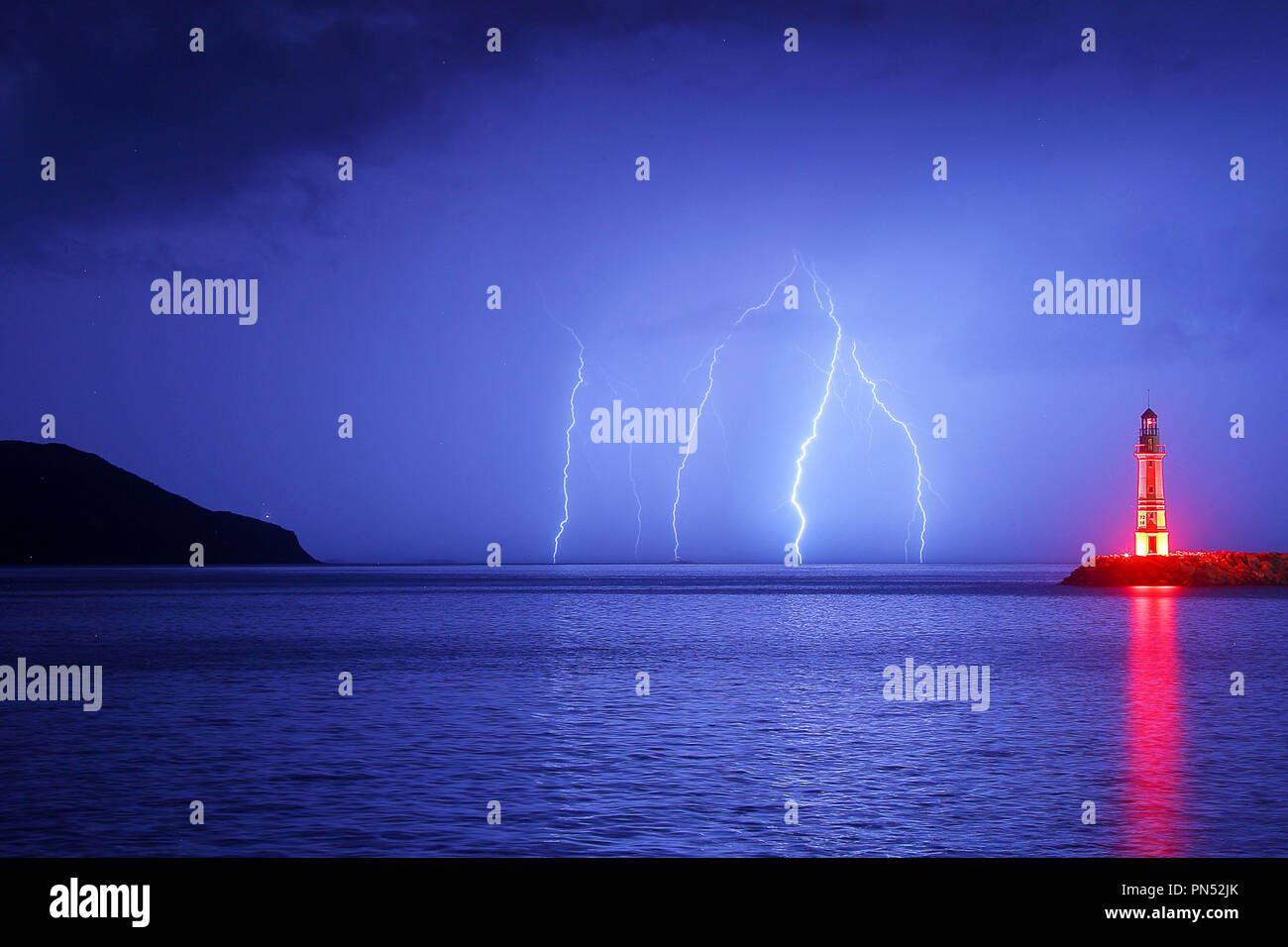 lighthouse and lightning over a stormy night Stock Photo - Alamy