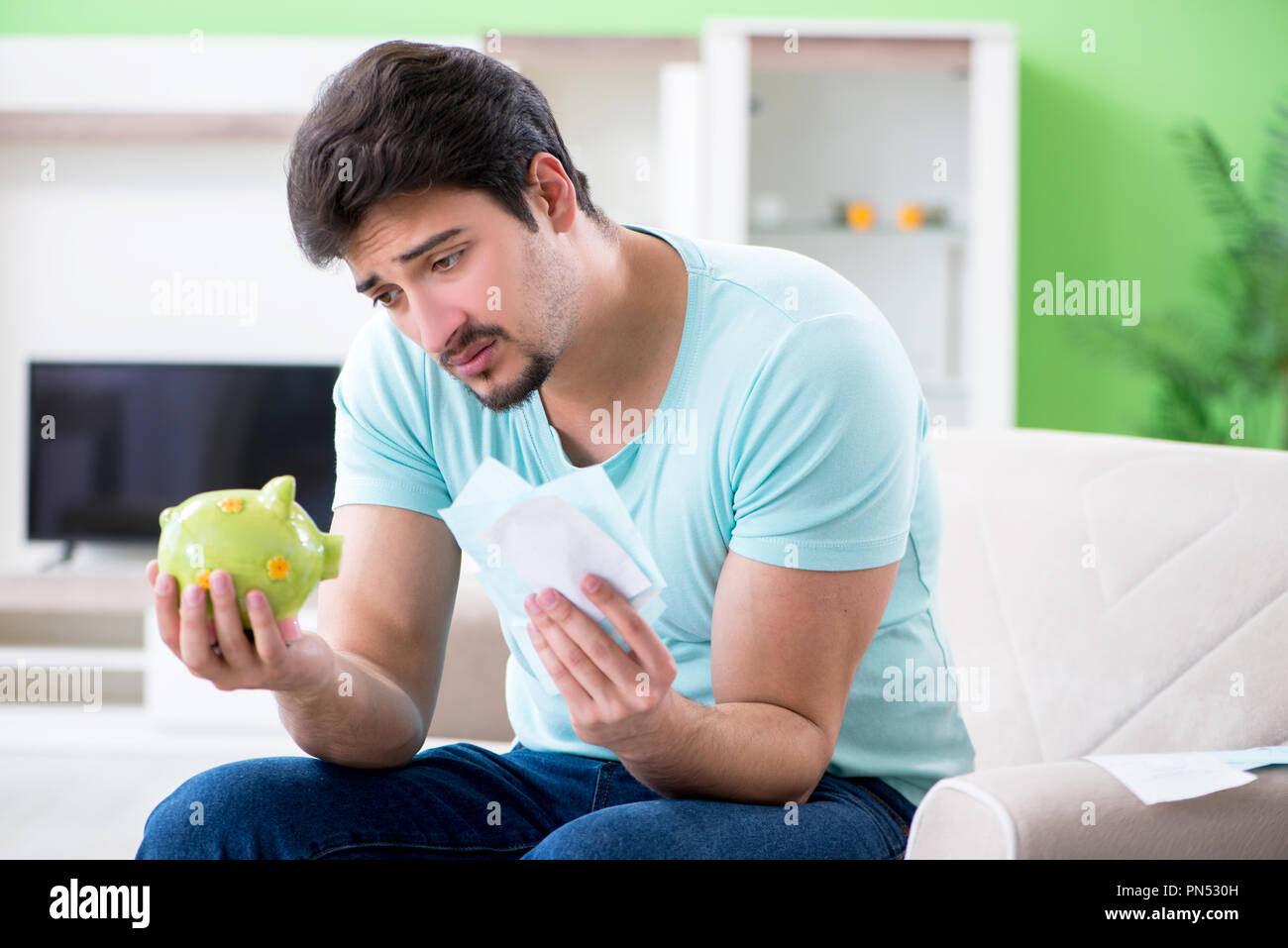 Young man struggling with personal finance and bills Stock Photo - Alamy