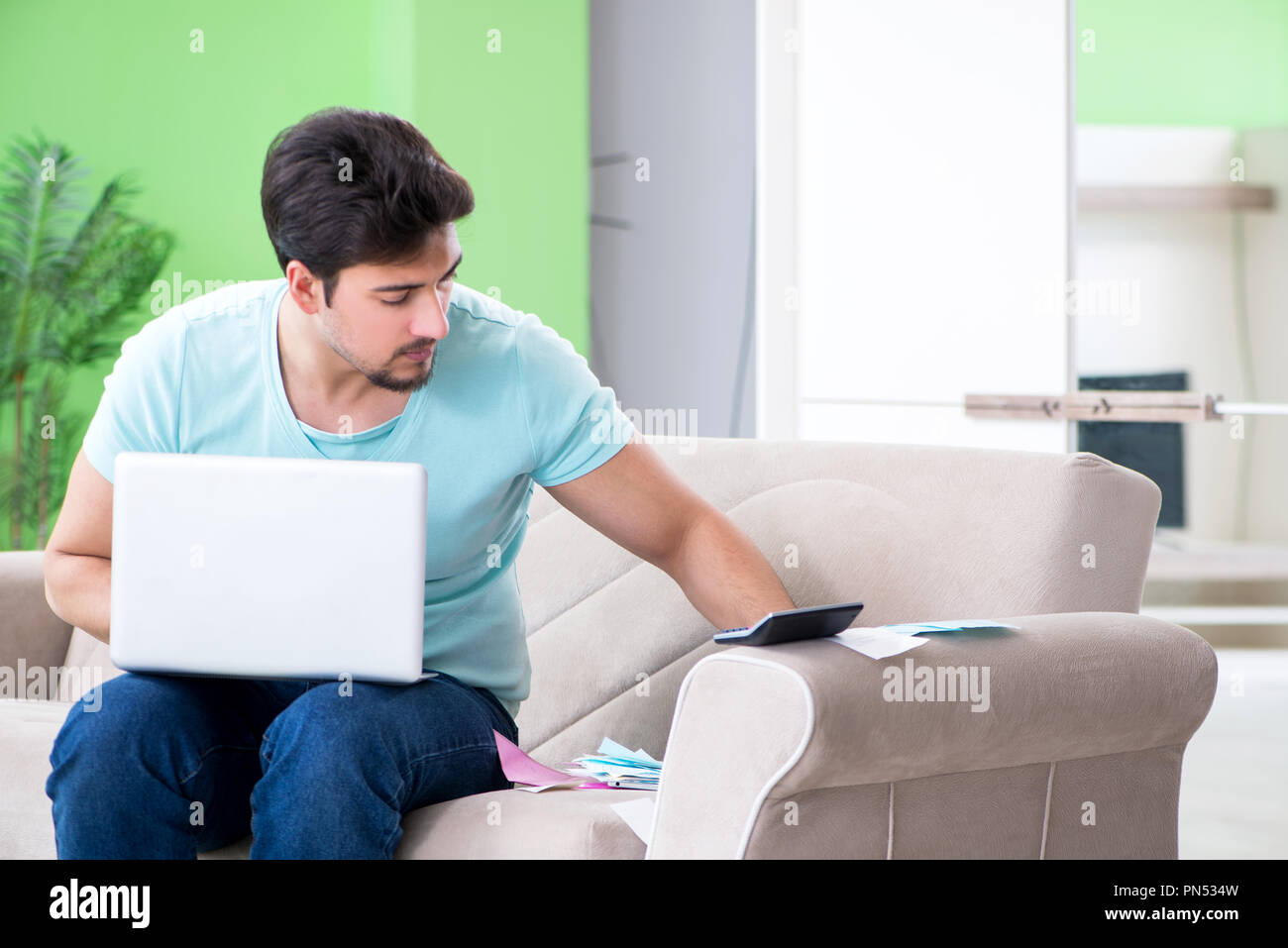 Young man struggling with personal finance and bills Stock Photo - Alamy