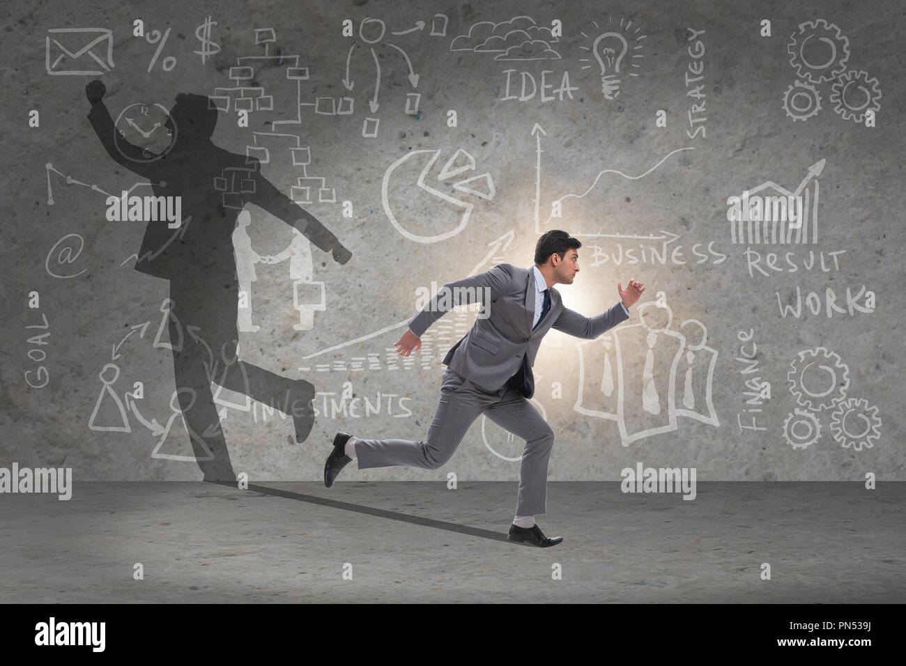 Businessman and his shadow in business concept Stock Photo - Alamy