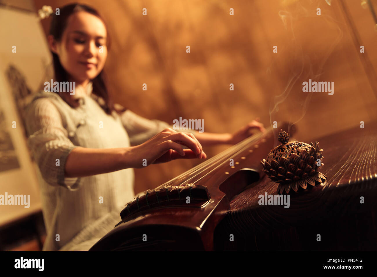 Young woman playing the lyre Stock Photo - Alamy