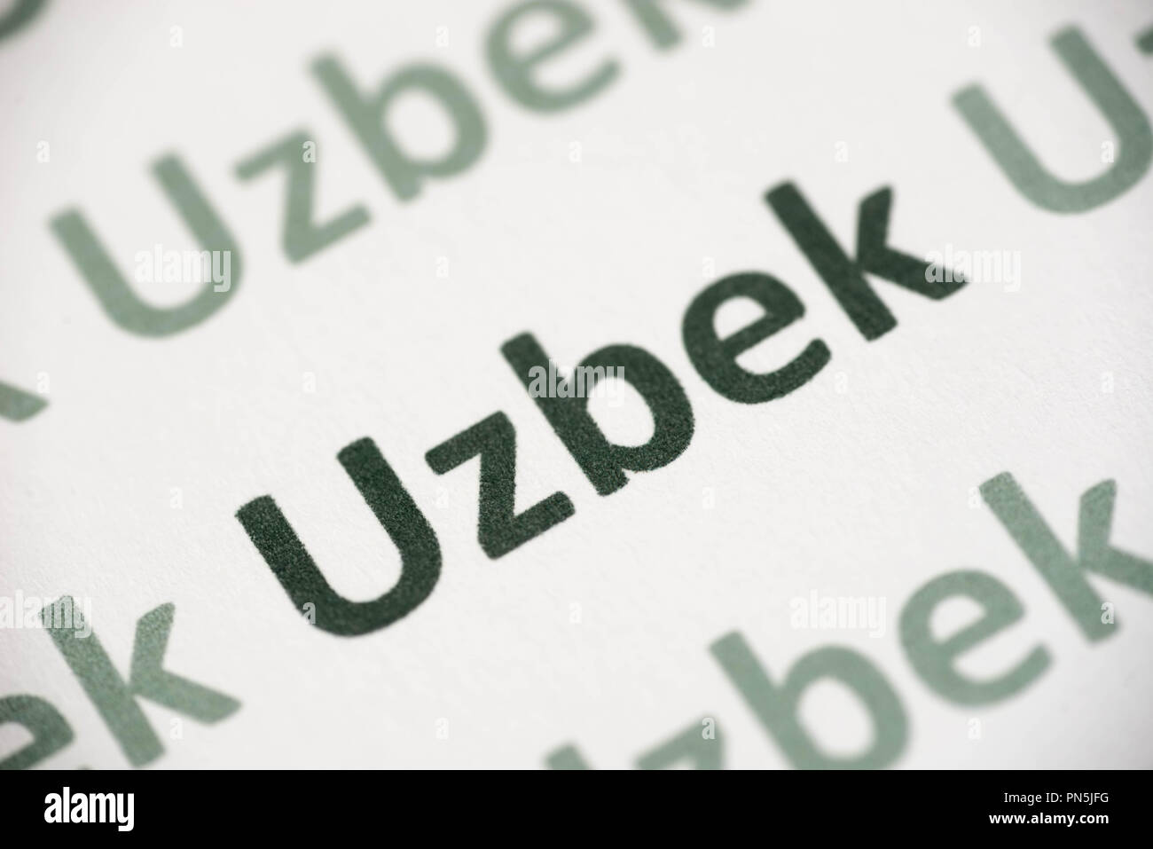 word Uzbek language printed on white paper macro Stock Photo - Alamy