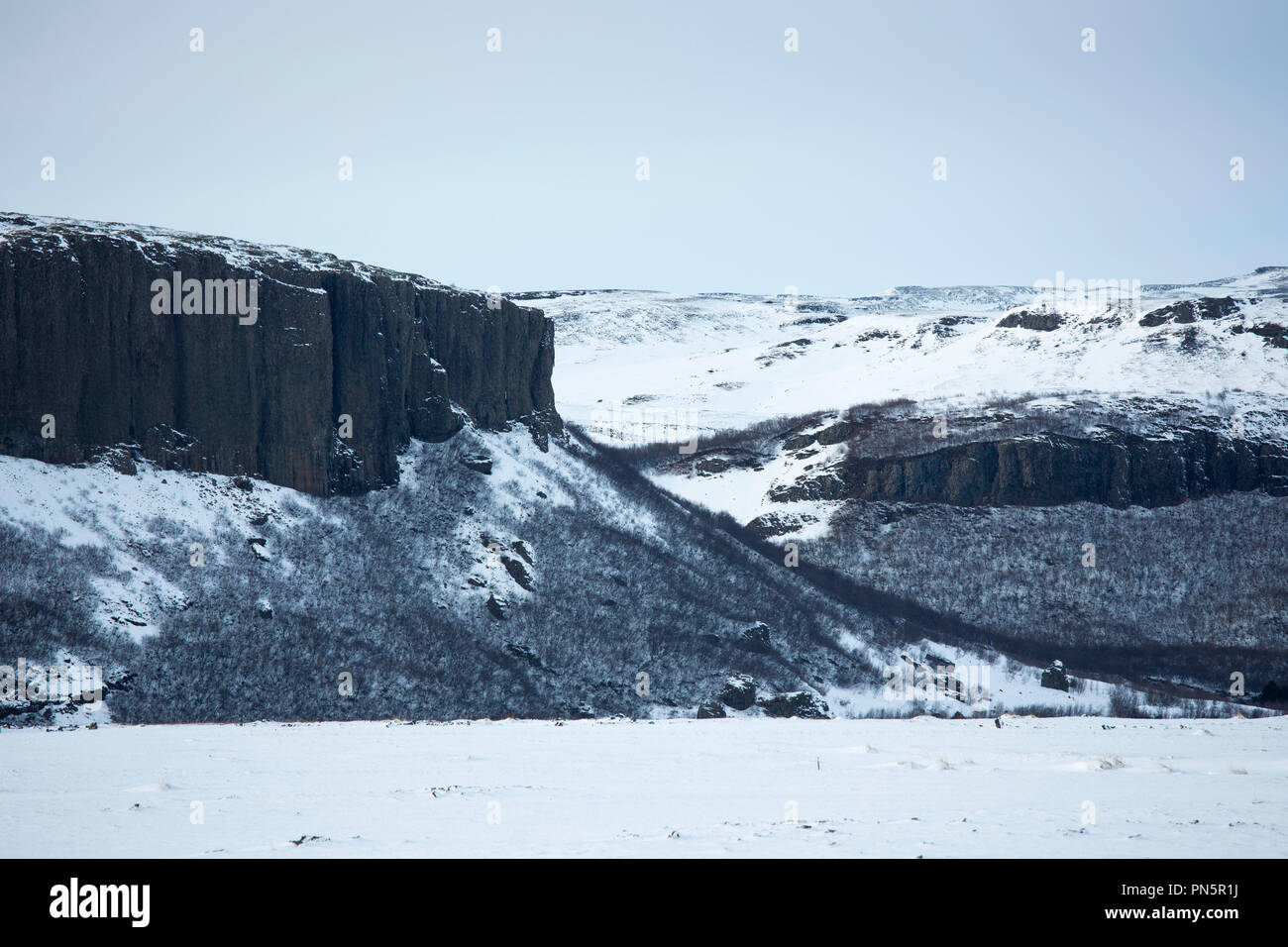 Typical dramatic Icelandic landscape of snow covered mountains of ...