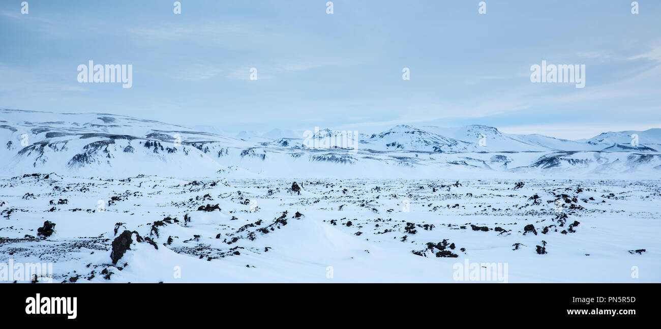 Empty landscape of mountains and snow-covered lava fields of volcanic ...
