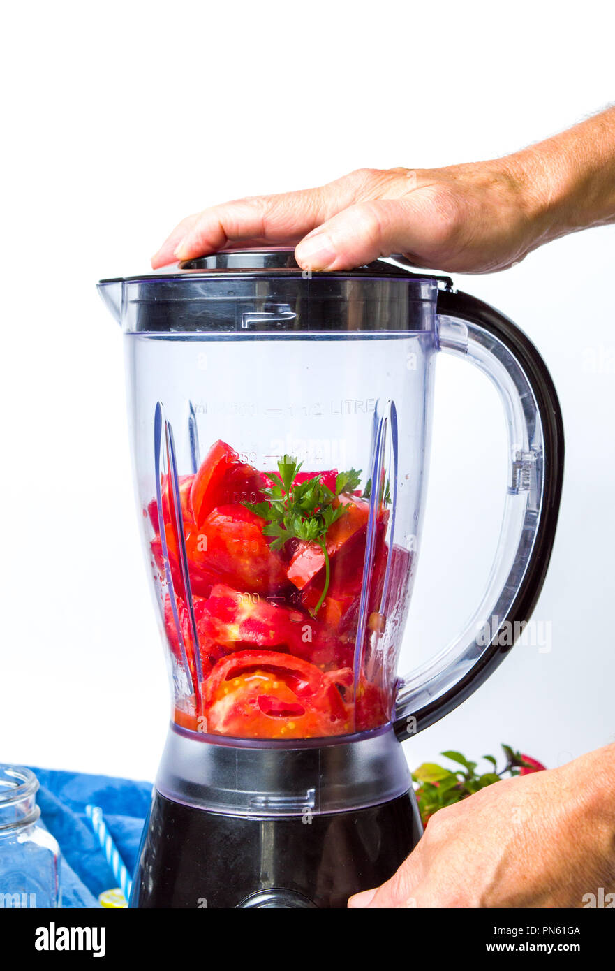 Man using blender to make a healthy tomato smoothie Stock Photo - Alamy