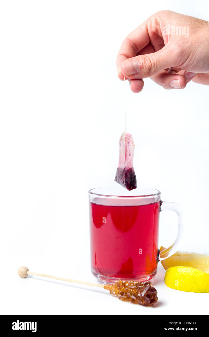 Hand taking out tea bag out of the glass isolated Stock Photo - Alamy