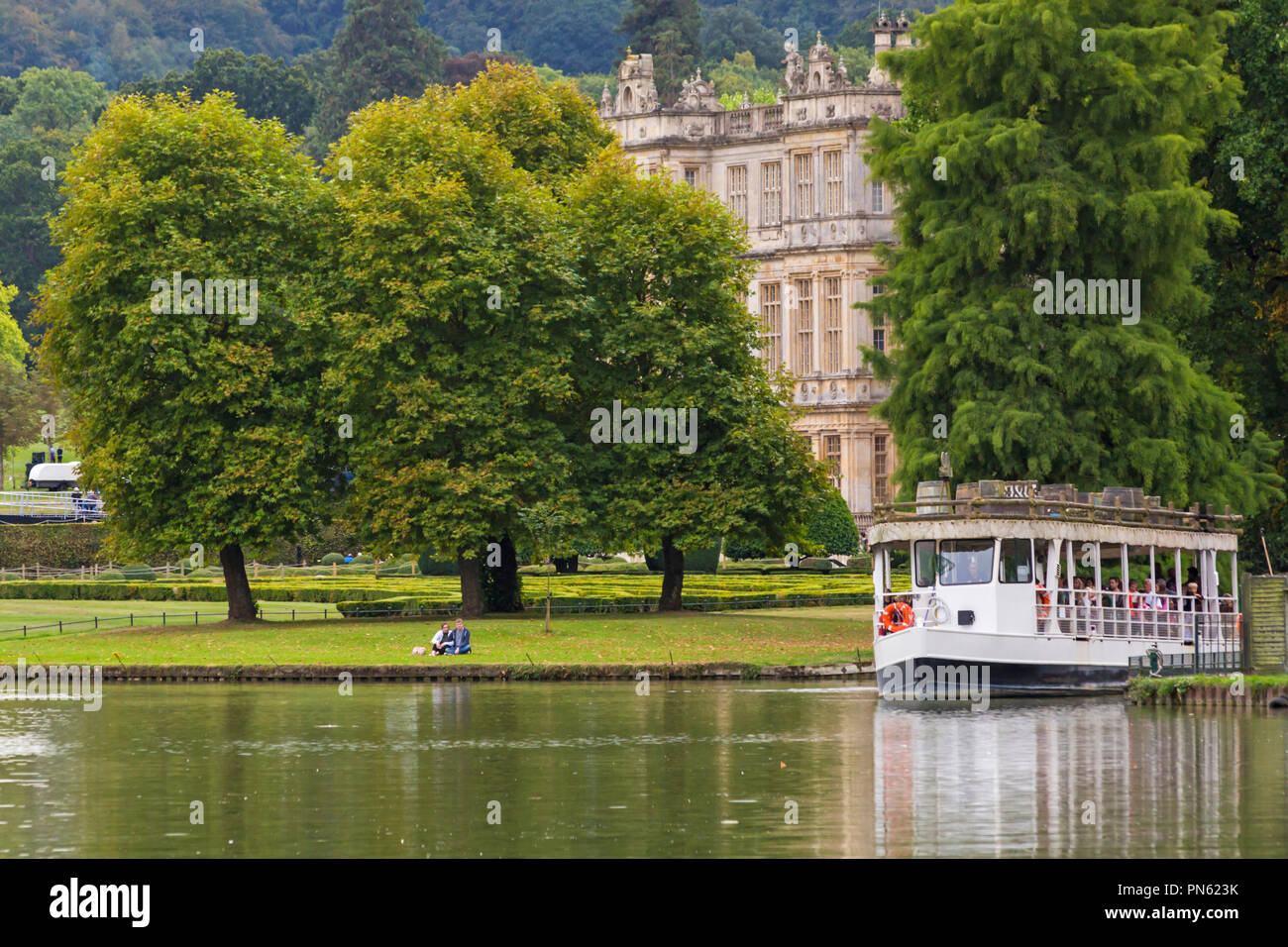 Visitors taking Jungle Cruise ride on boat with Longleat House in the ...