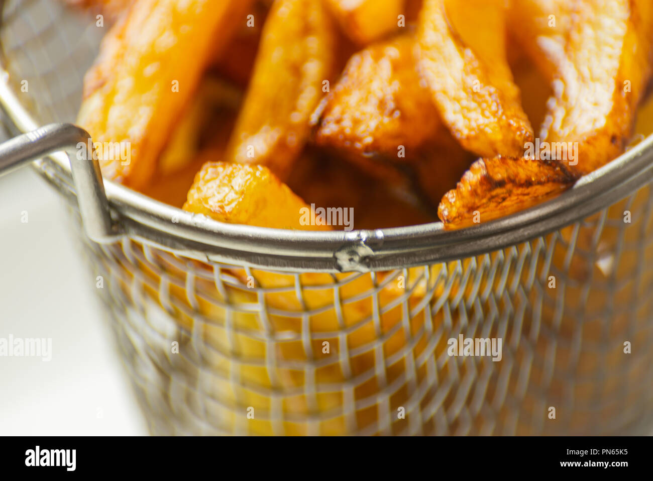 closeup of golden fries prepared from fresh potatoes, greasy but ...
