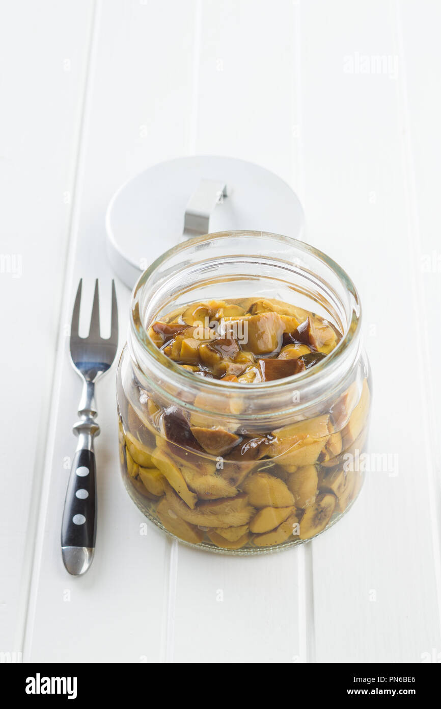 Pickled mushrooms. Marinated boletus in jar Stock Photo - Alamy
