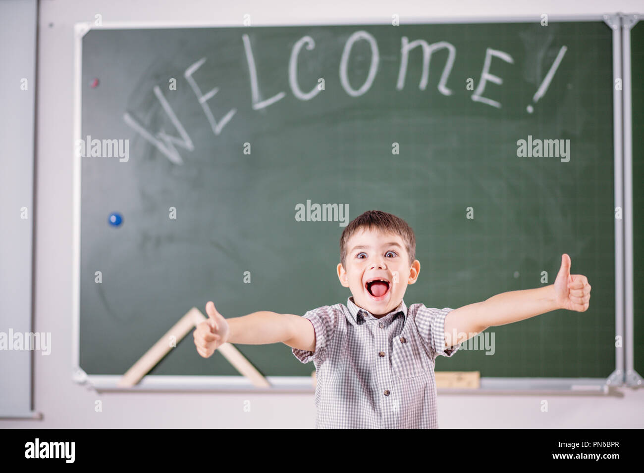 smiling boy thumb up going to school for first time. Kid indoor class ...