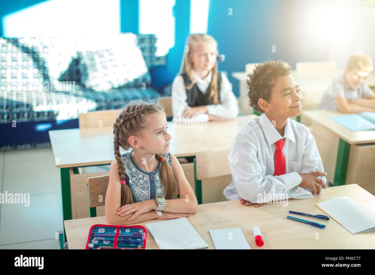 school children participating actively in class. Education, learning ...