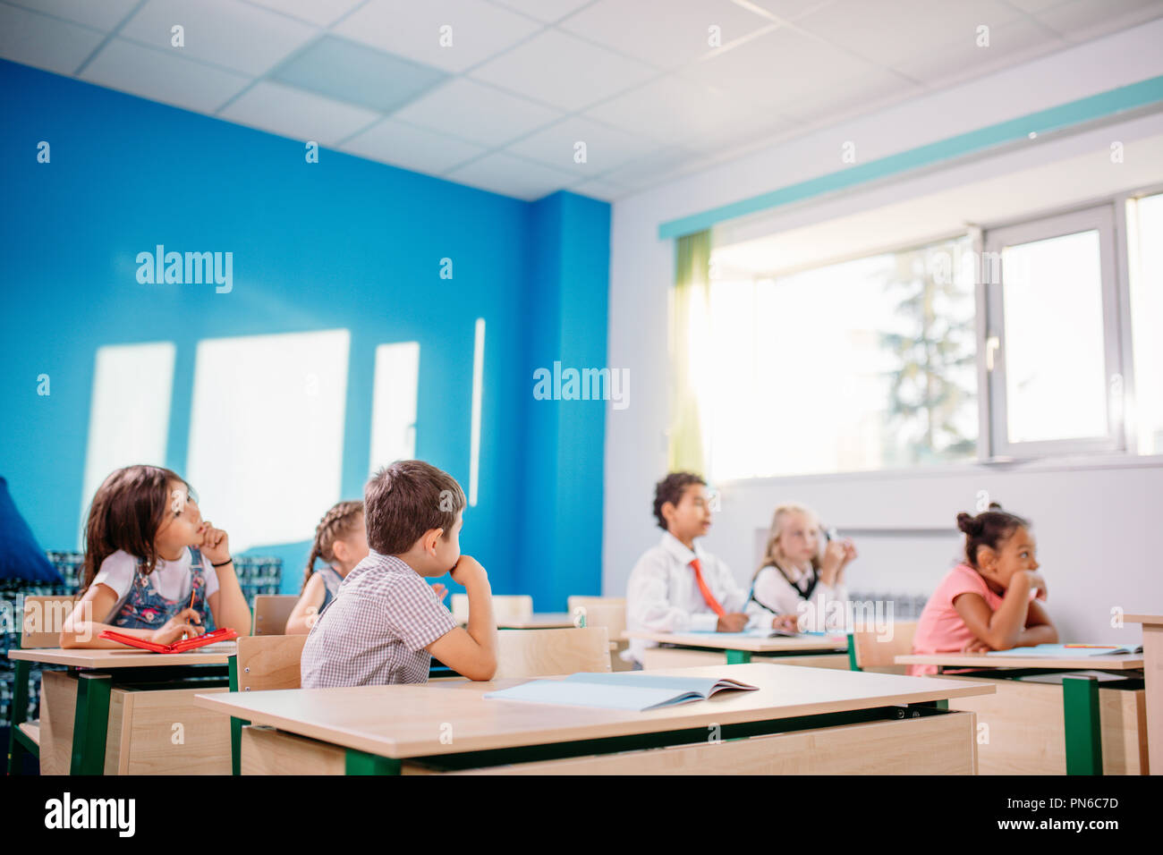 school children participating actively in class. Education, learning ...