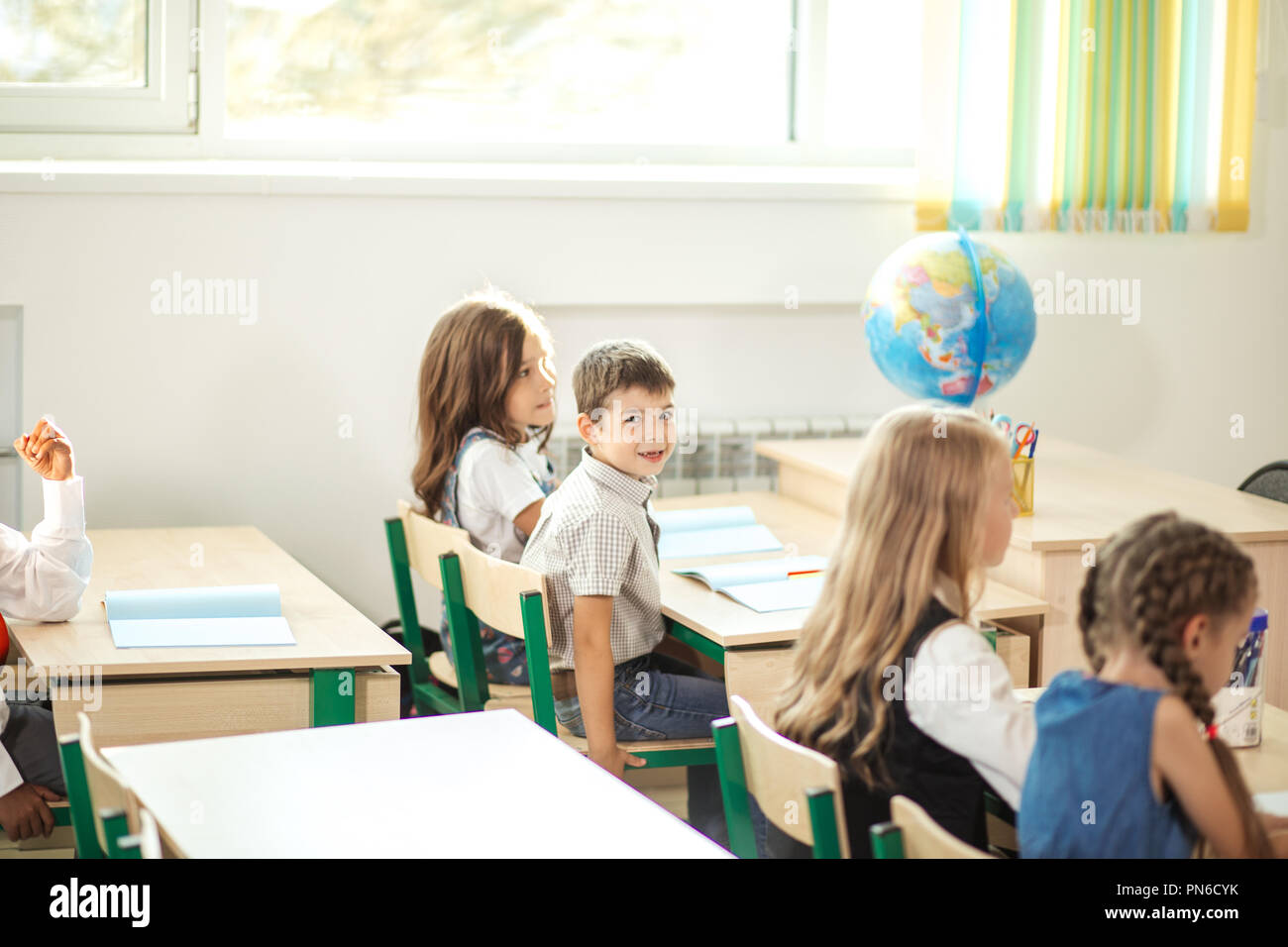 school children participating actively in class. Education, learning ...