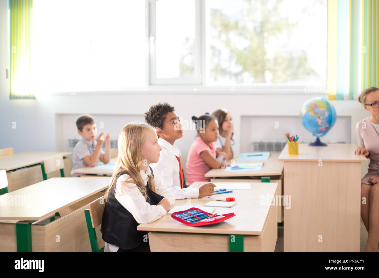 school children participating actively in class. Education, learning ...