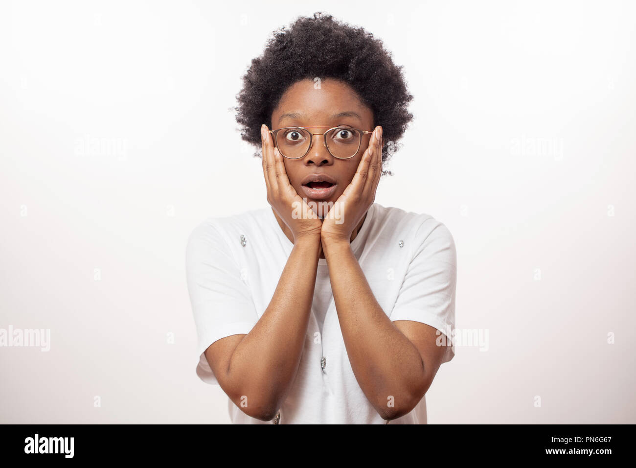 puzzled woman touching her face with palms Stock Photo - Alamy