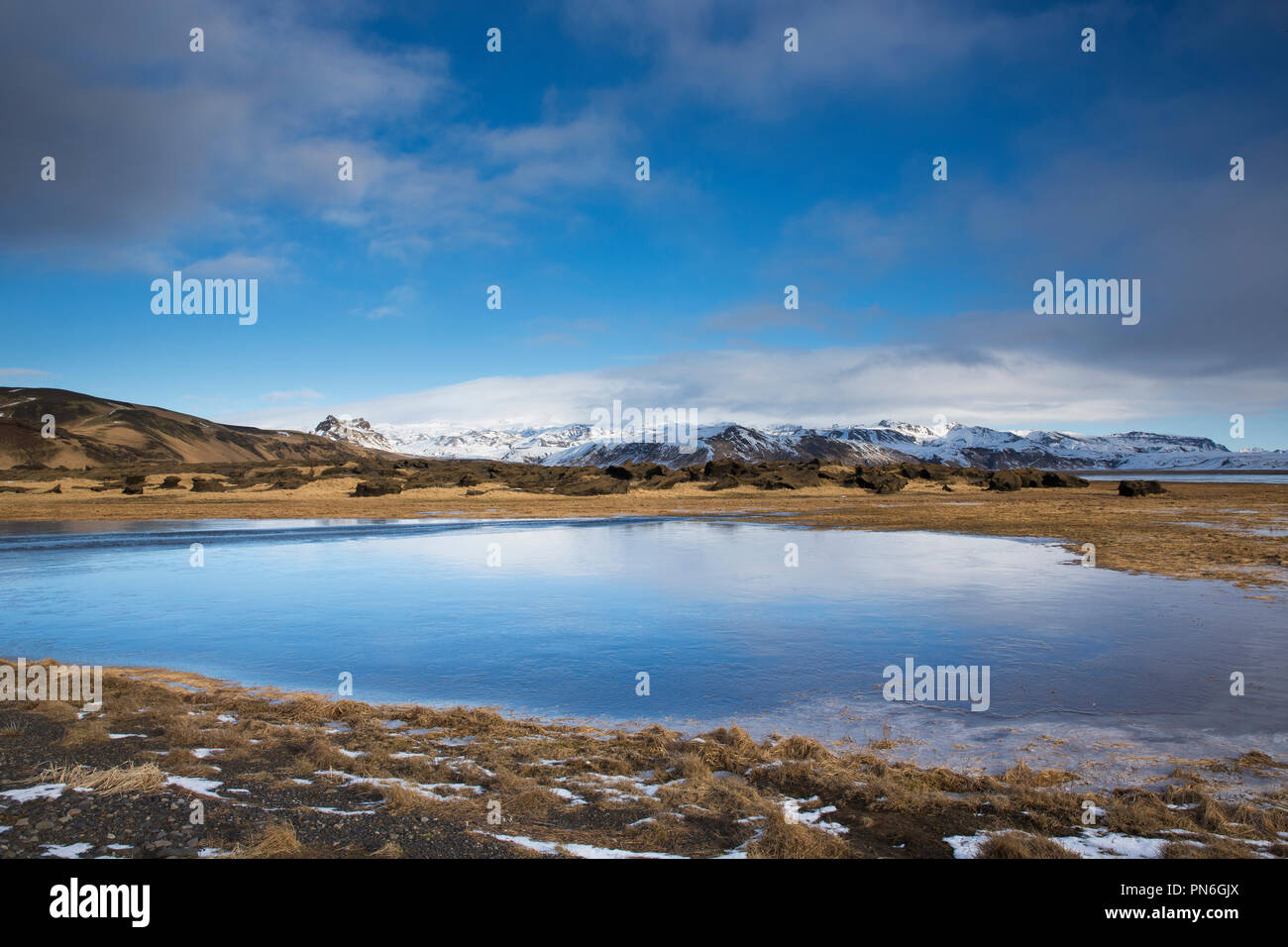 Typical Icelandic landscape of snow covered mountains and melting snow ...