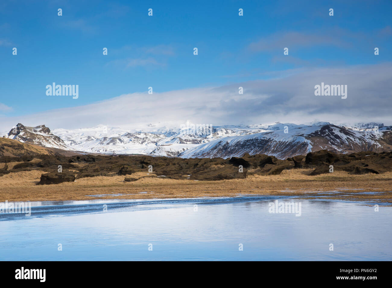 Typical Icelandic landscape of snow covered mountains and melting snow ...