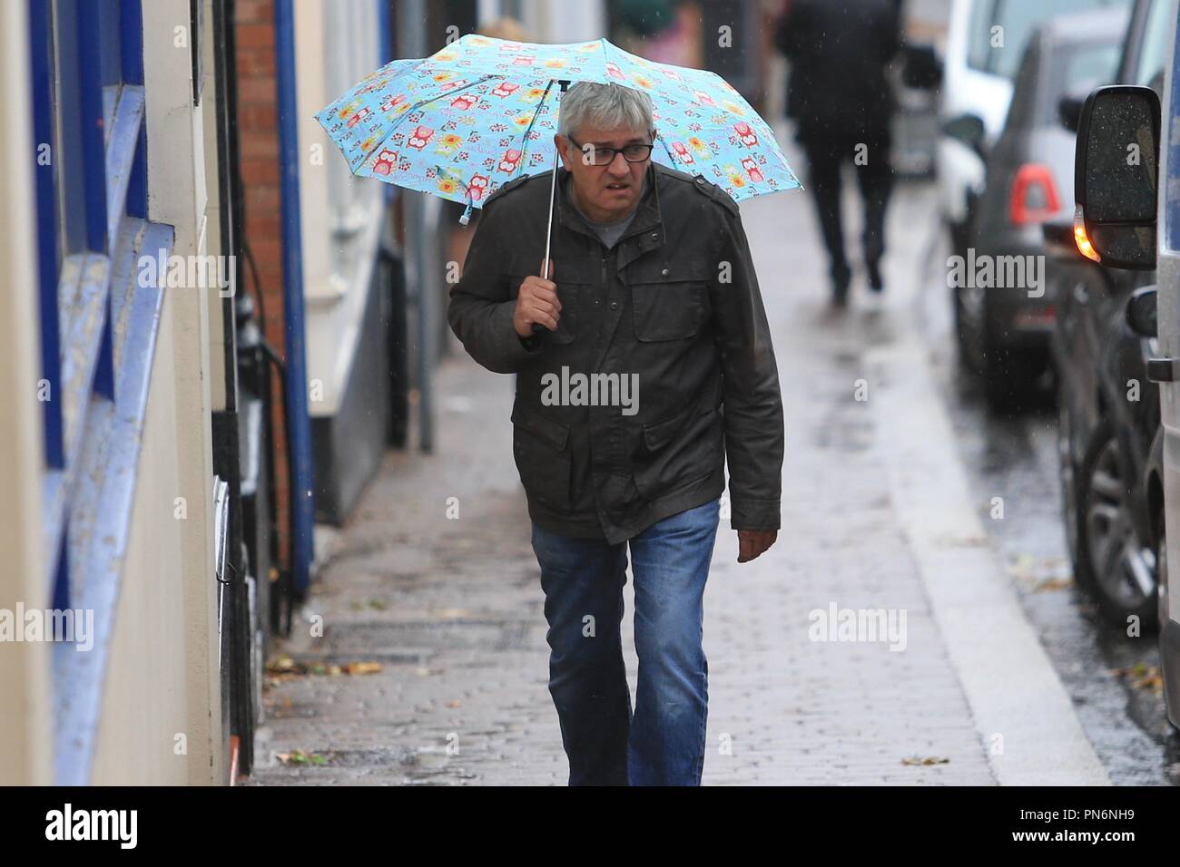 People walking on a street in the rain with umbrellas. UK Stock Photo ...